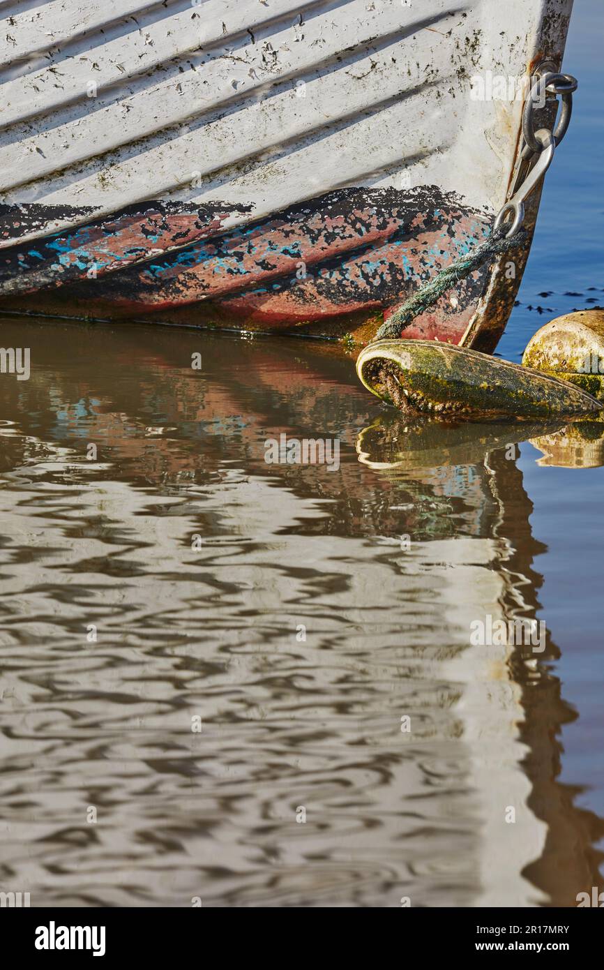 A boat bow and its reflection in the harbour water, in Teignmouth ...