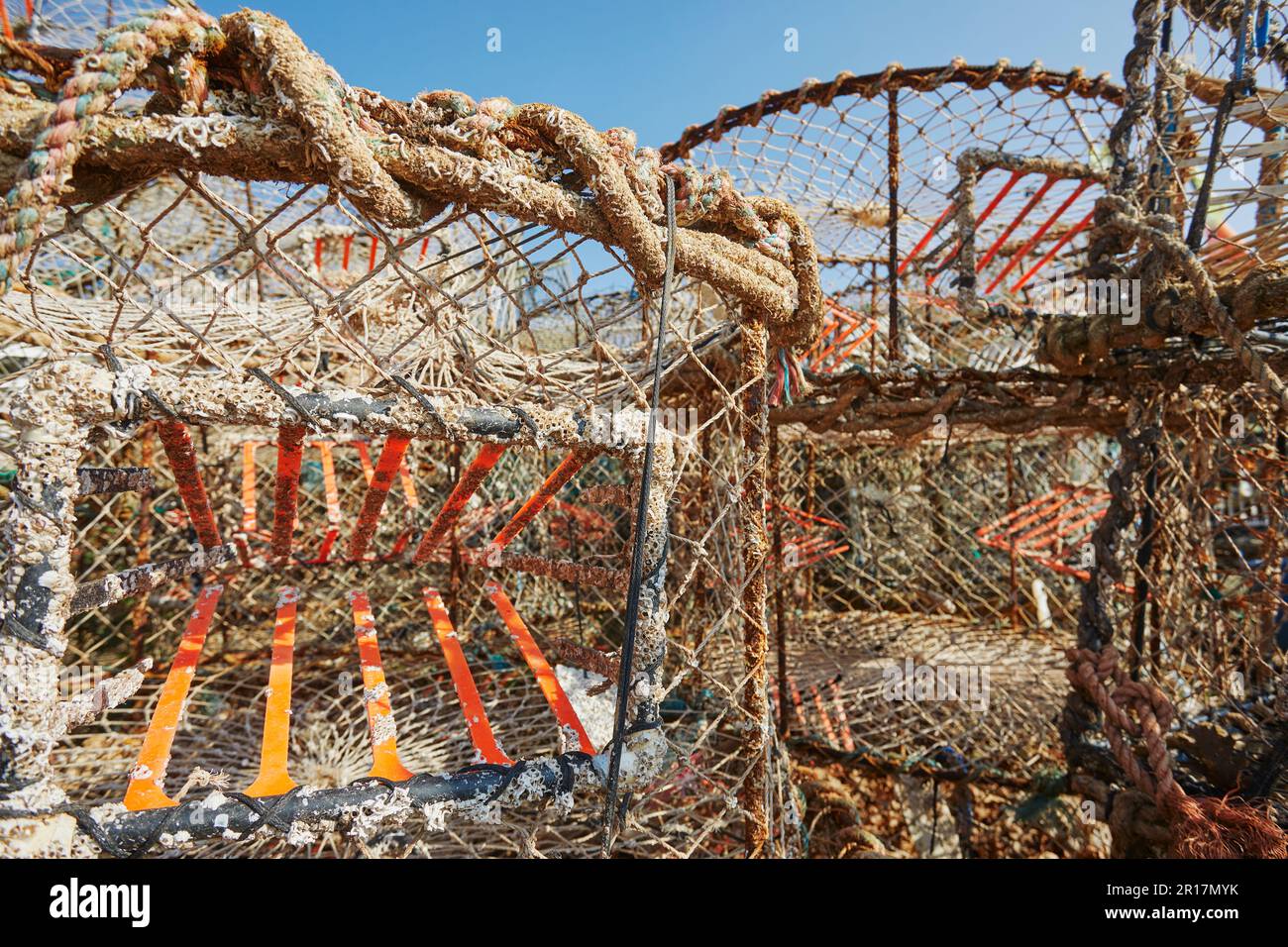 A tangled pile of lobster pots and crab pots on the harbourside in ...