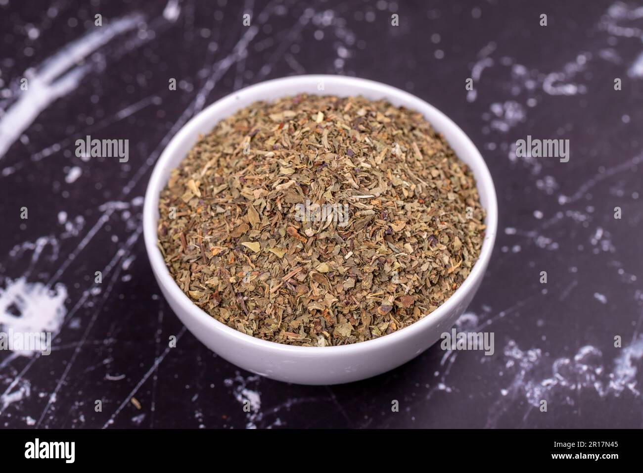 Dried crushed basil on dark background. Dried ground basil powder ...