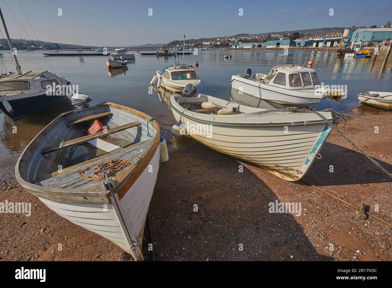 Boats pulled up on the shore in the harbour, inside the estuary of the ...