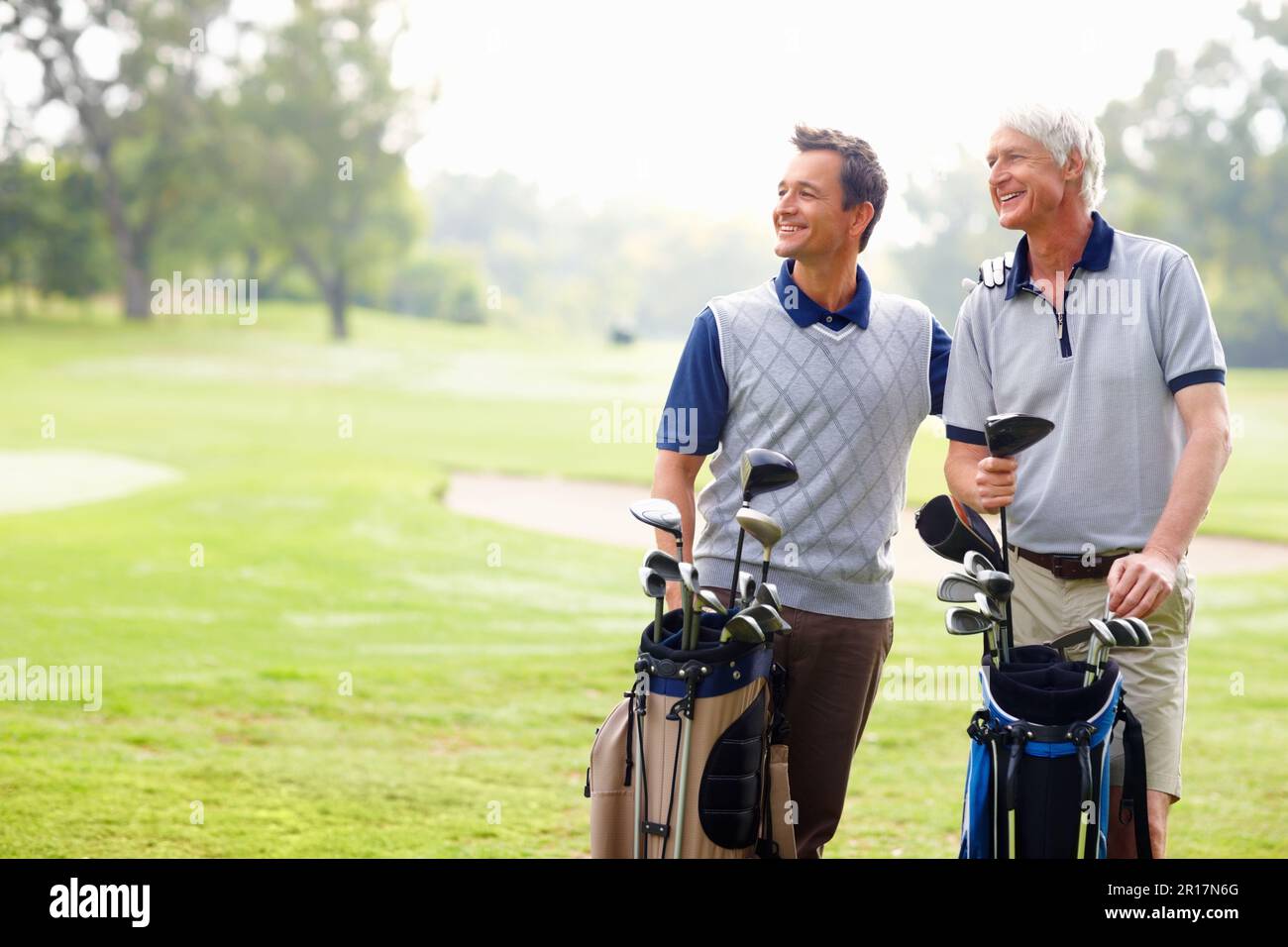 Happy father and son on a golf course. Happy father and son on a golf ...