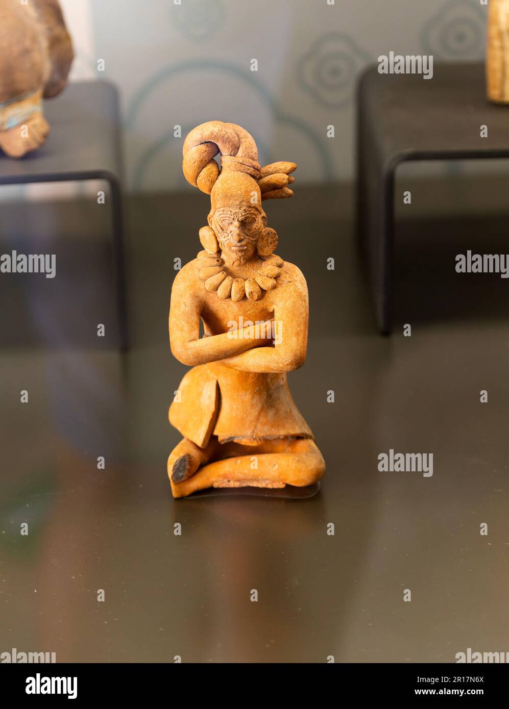 Figurine model of sitting man with facial scarring, from Jaina, Late ...