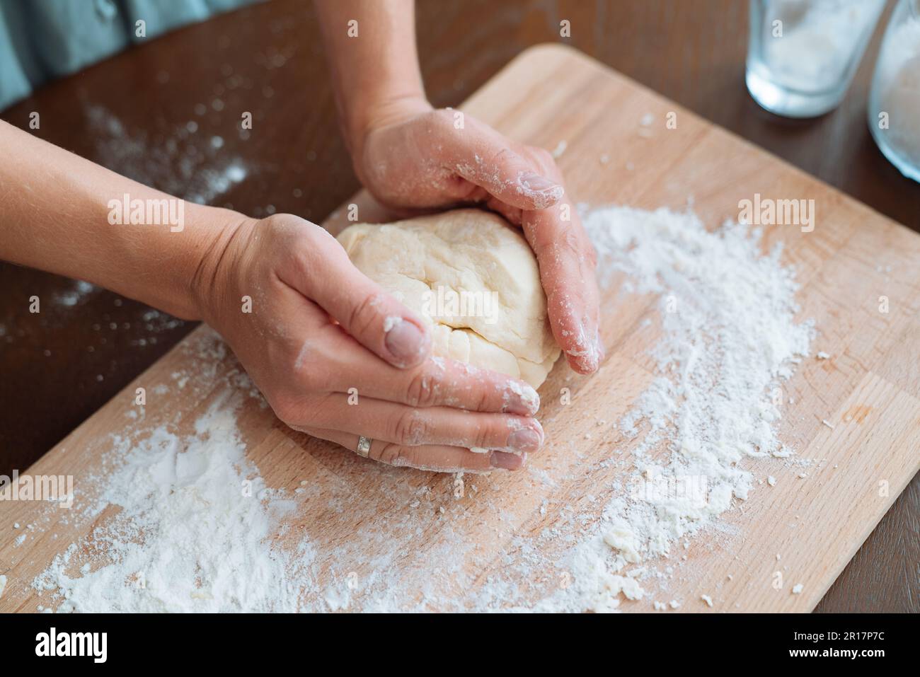 Female hands cutting raw dough hi-res stock photography and images - Alamy
