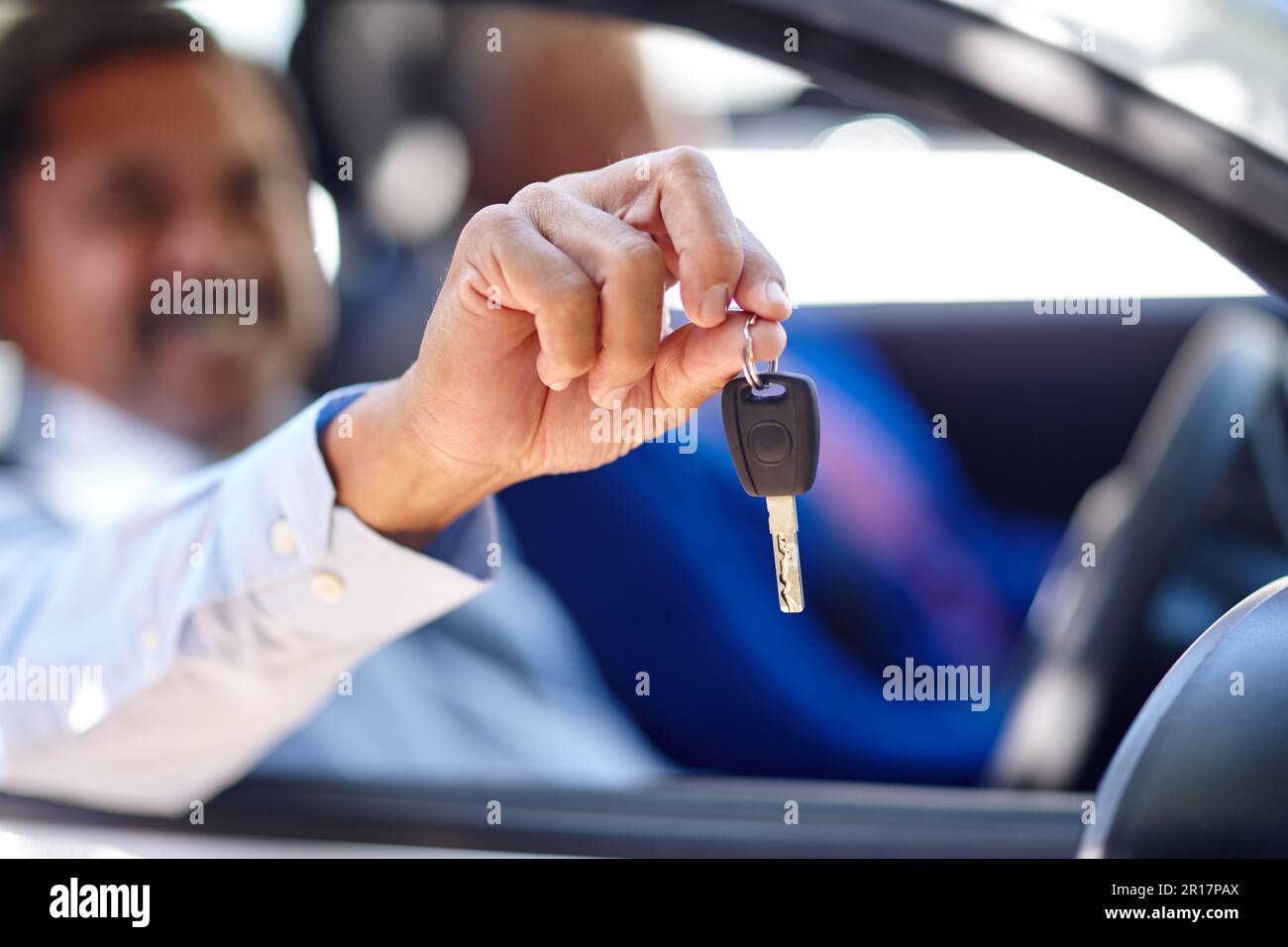 Lets take a drive. a senior man sitting in a car with his wife and ...