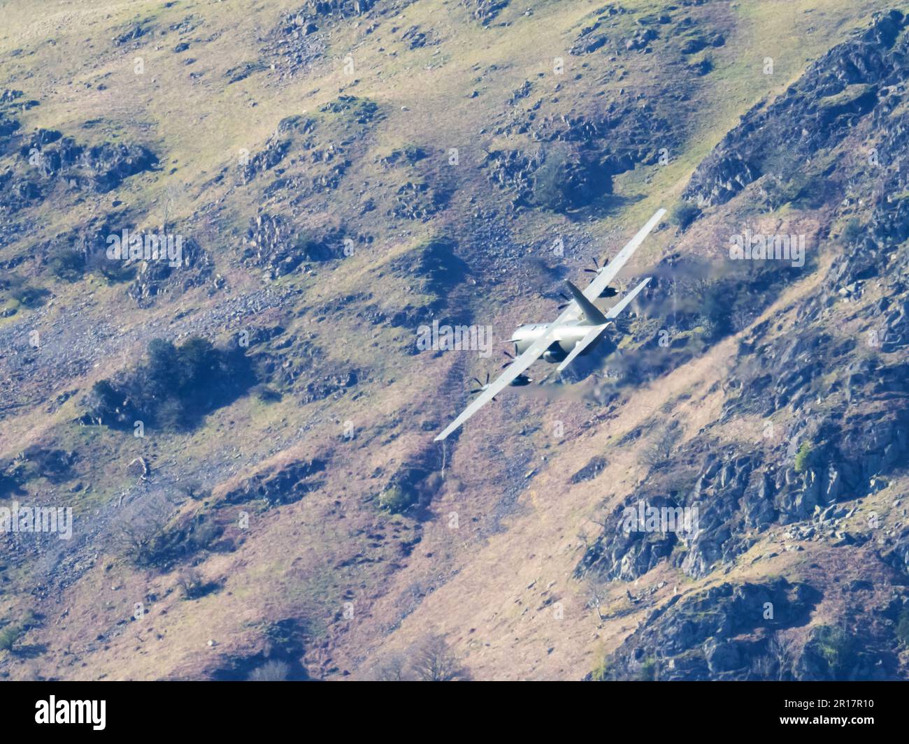 An RAF cargo plane flying over Ambleside in the Lake District, UK Stock ...