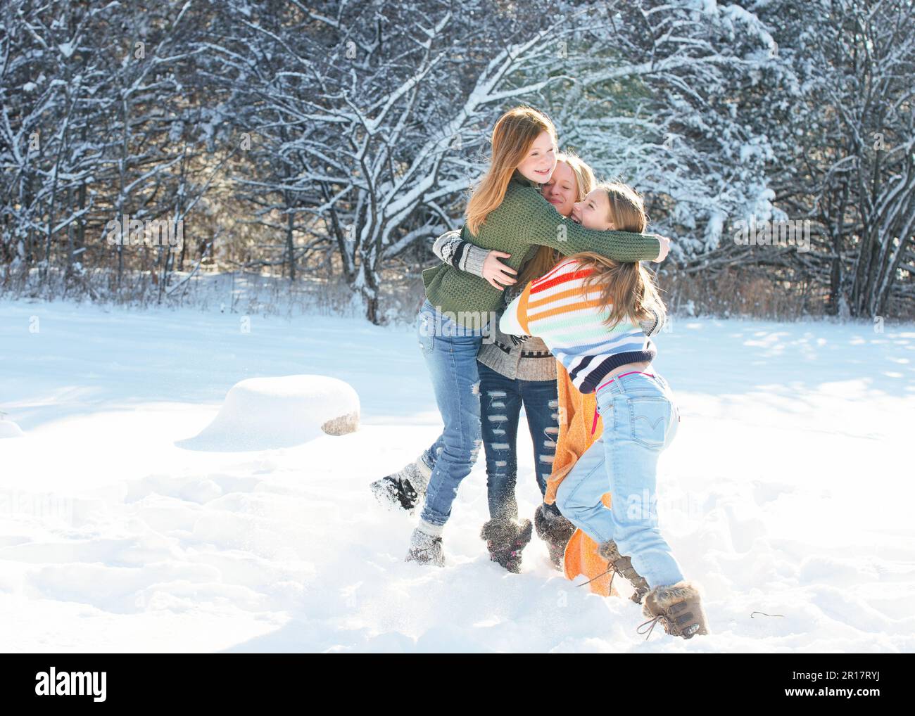Three tween girls playing in the snow on winter day Stock Photo - Alamy