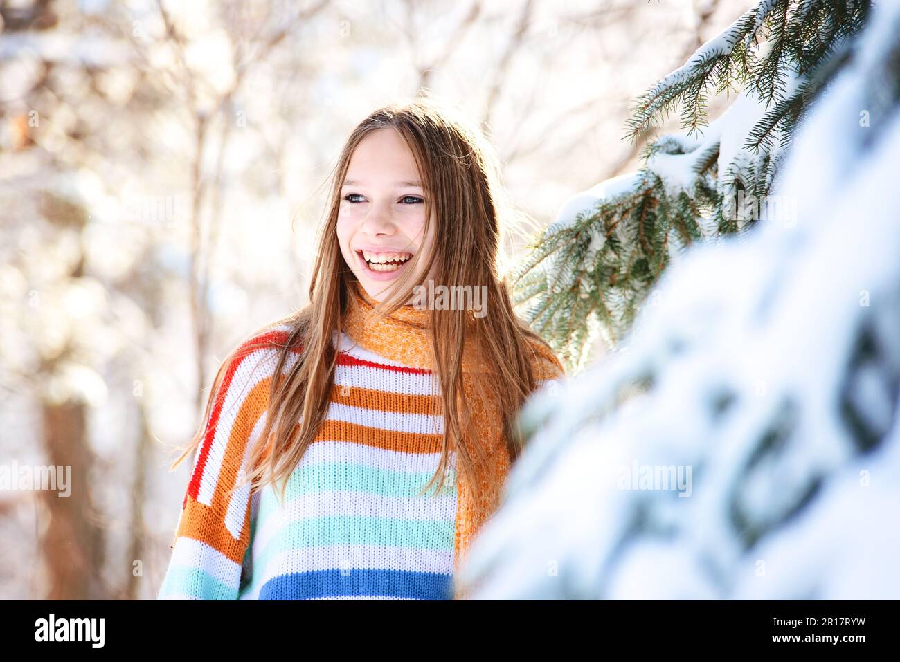 Beautiful happy tween girl with blond hair in the snow Stock Photo - Alamy