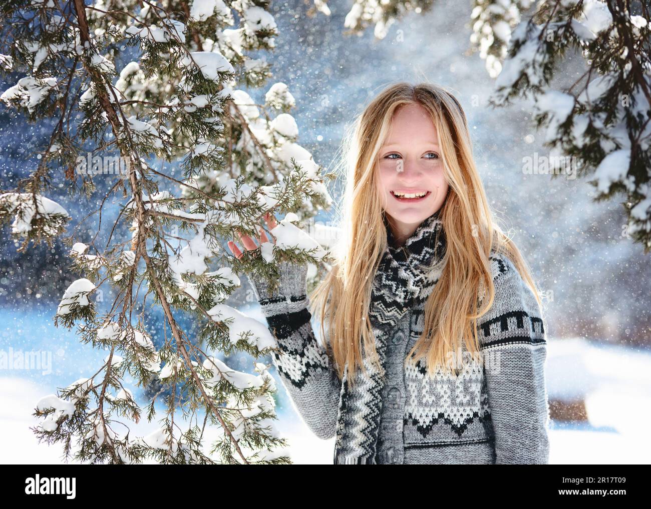 Happy tween girl with blond hair in the snow Stock Photo - Alamy