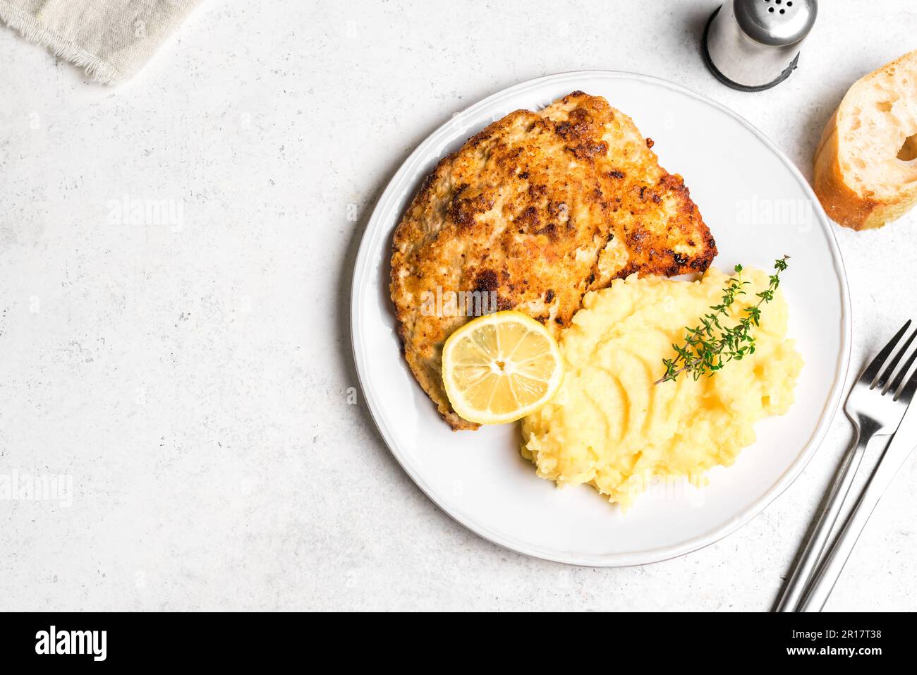 German schnitzel with fresh mashed potatoes on white background, copy ...