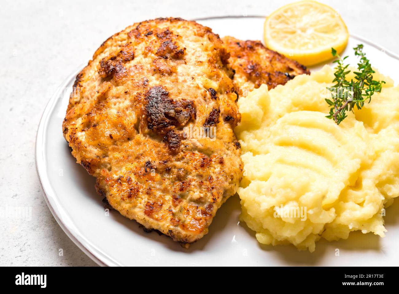 German schnitzel with fresh mashed potatoes close up. Homemade breaded ...