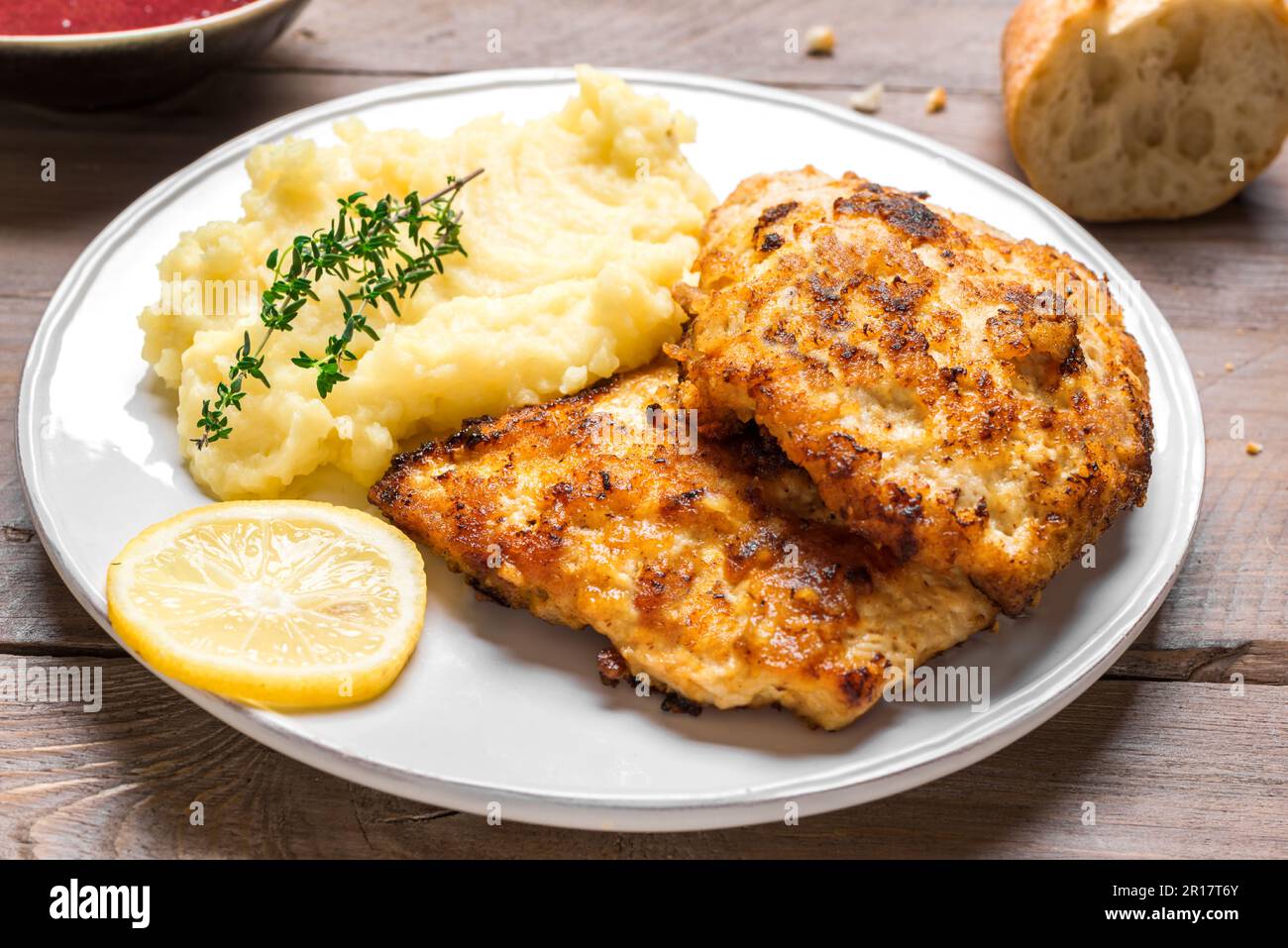 German schnitzel with fresh mashed potatoes close up. Homemade breaded ...