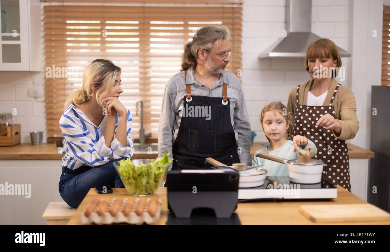 Multi-generational family members explore new and tasteful recipes on a ...