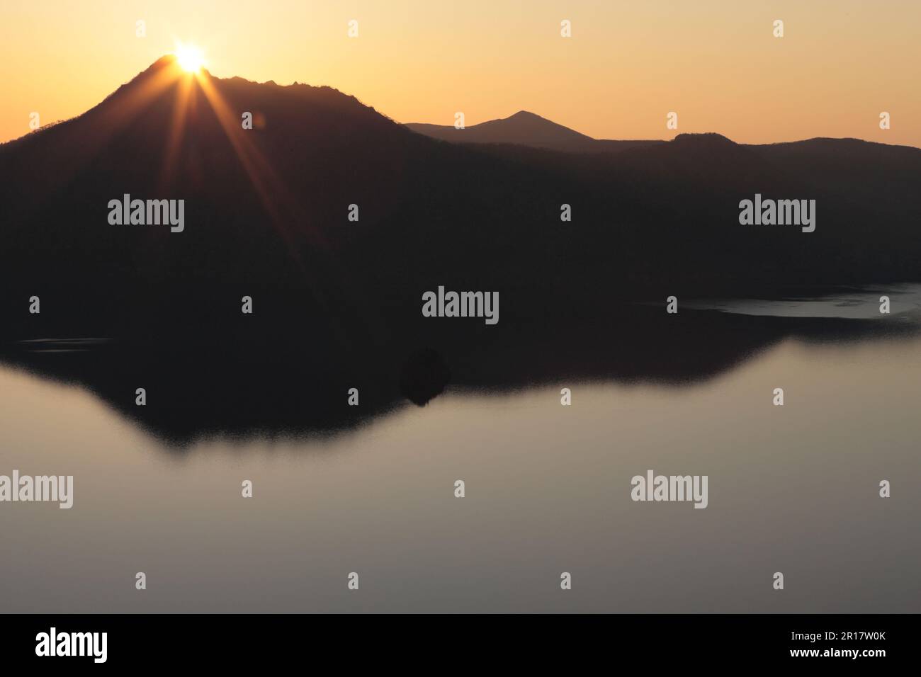 Morning sun coming out on the top of Mashu-Dake mountain and Lake Mashu ...