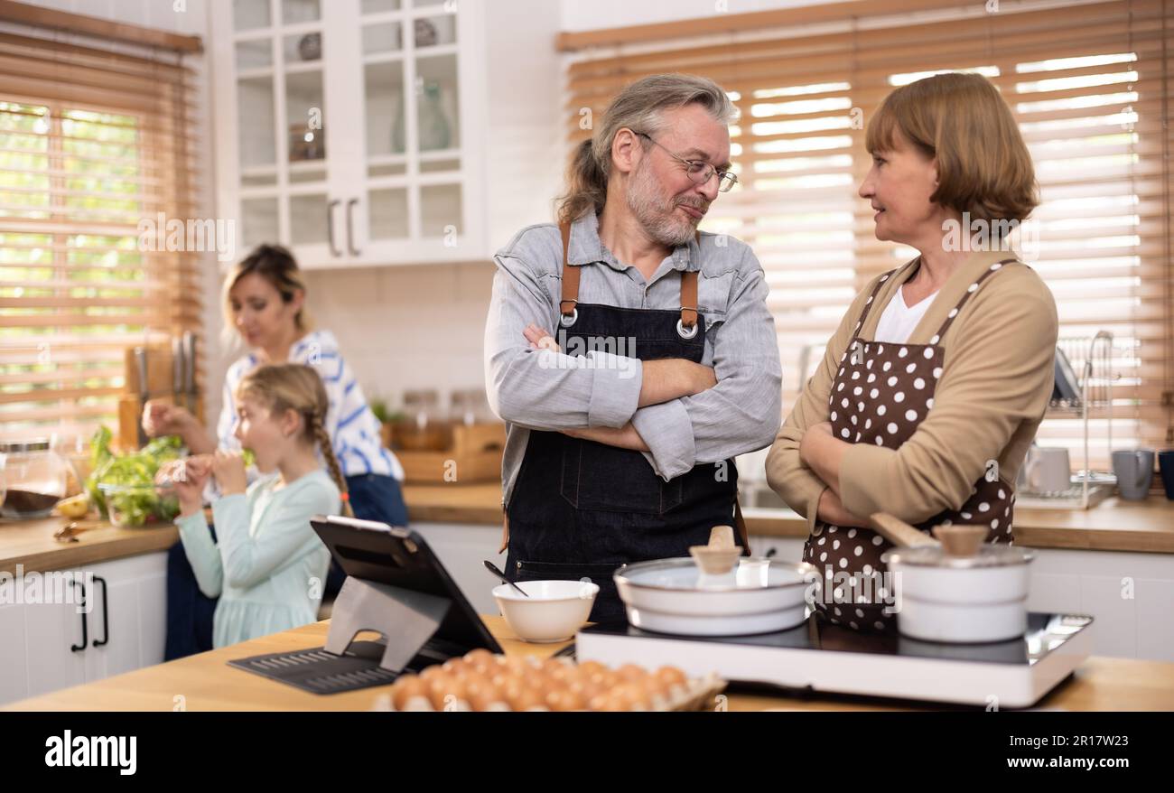 Multi-generational family members explore new and tasteful recipes on a ...