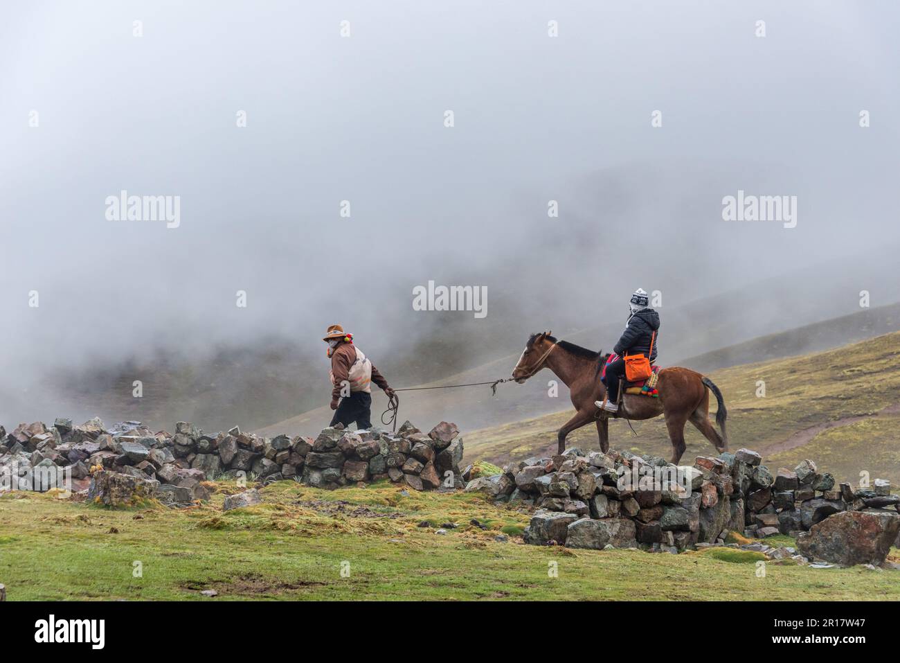 Countrymen helping tourists to reach the Mountain of 7 Colors, Peru ...