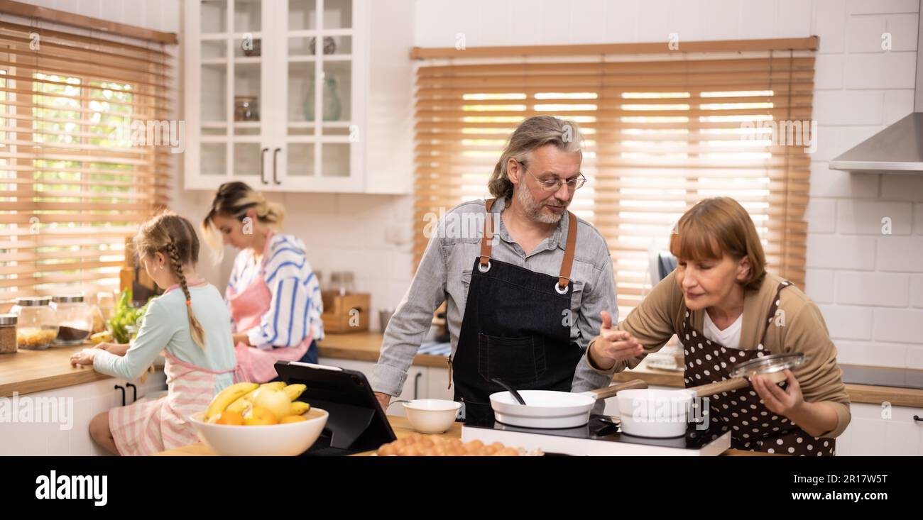 Multi-generational family members explore new and tasteful recipes on a ...