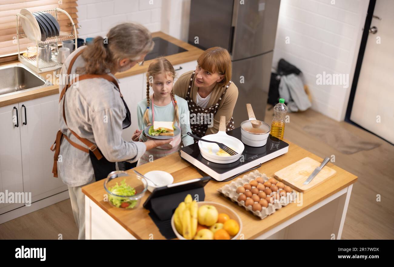 Multi-generational family members explore new and tasteful recipes on a ...