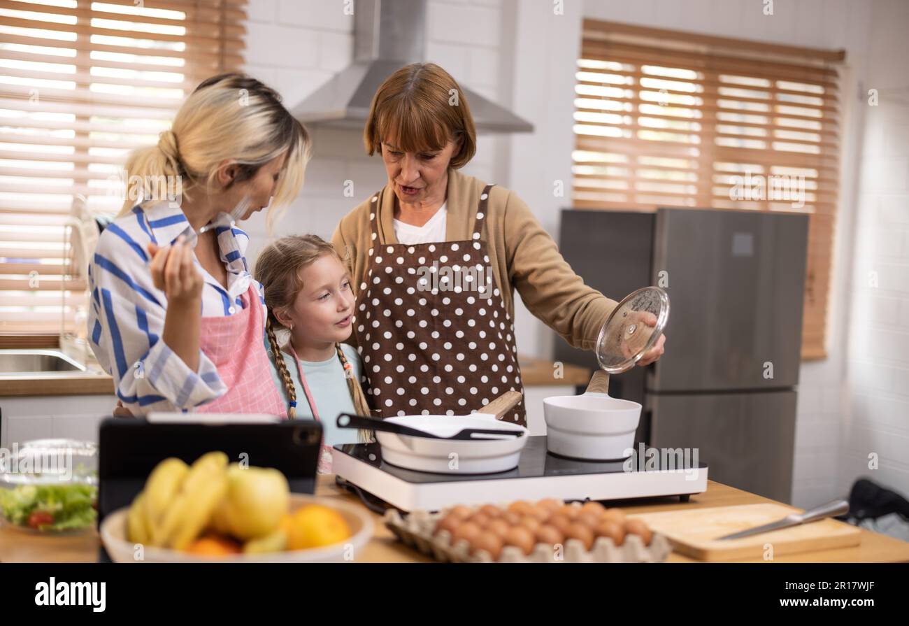 Multi-generational family members explore new and tasteful recipes on a ...
