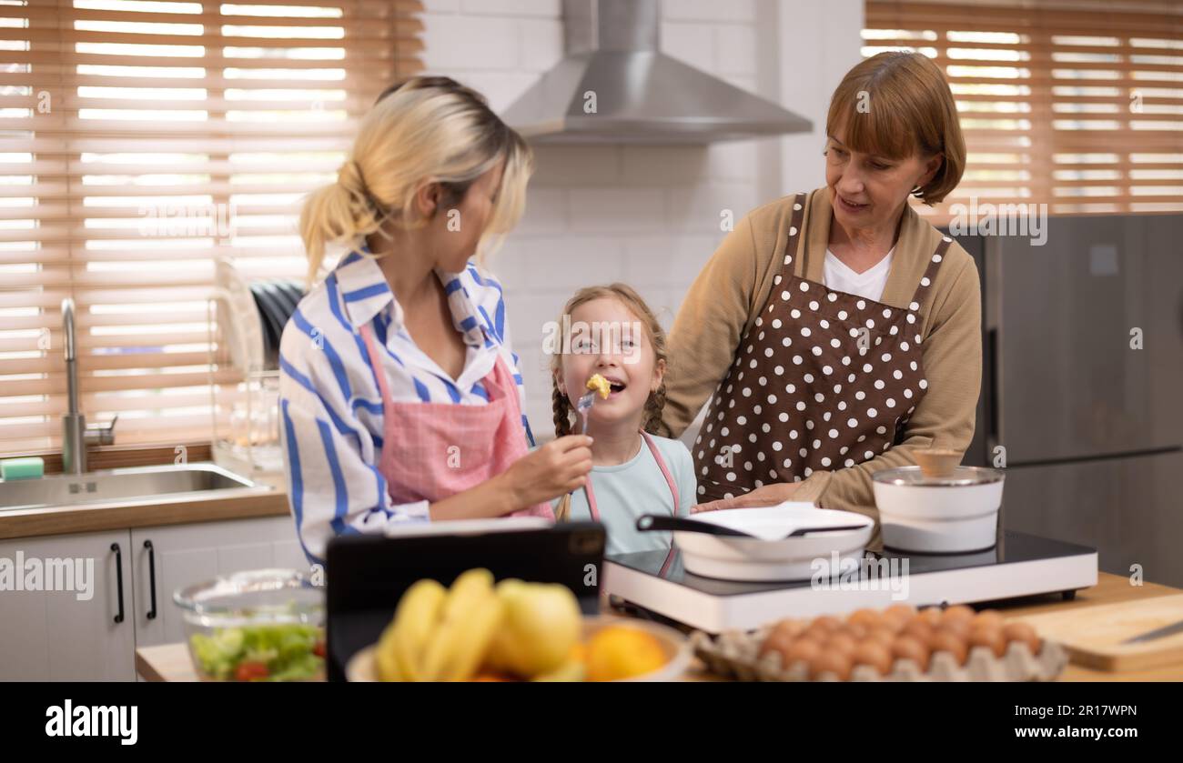 Multi-generational family members explore new and tasteful recipes on a ...