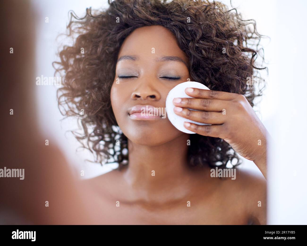 Reveal your glow. a beautiful young woman during her daily beauty ...