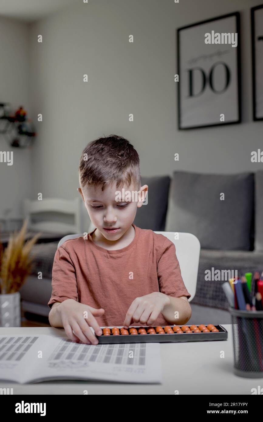 Little boy counting with the help of mental arithmetic. Mathematics in ...