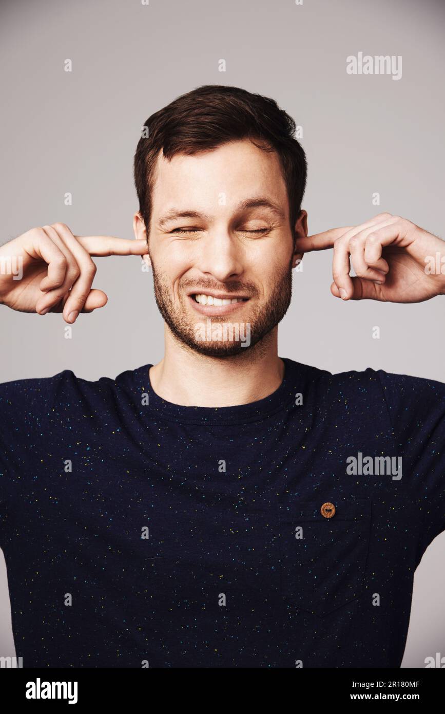 Block sound, man and finger in ears of a person loud music problem in a ...