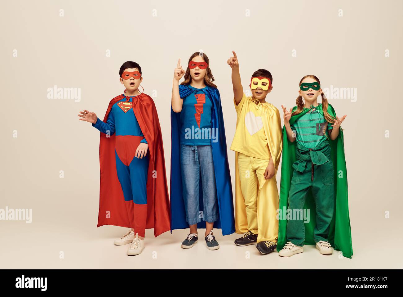 multicultural kids in colorful superhero costumes with cloaks and masks ...