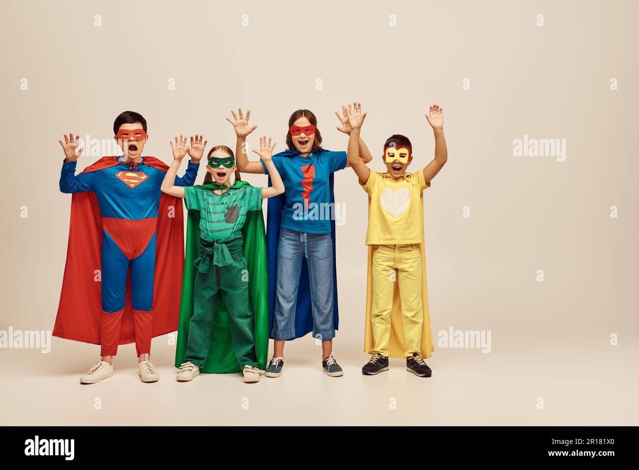 courageous multicultural kids in colorful costumes with cloaks and ...