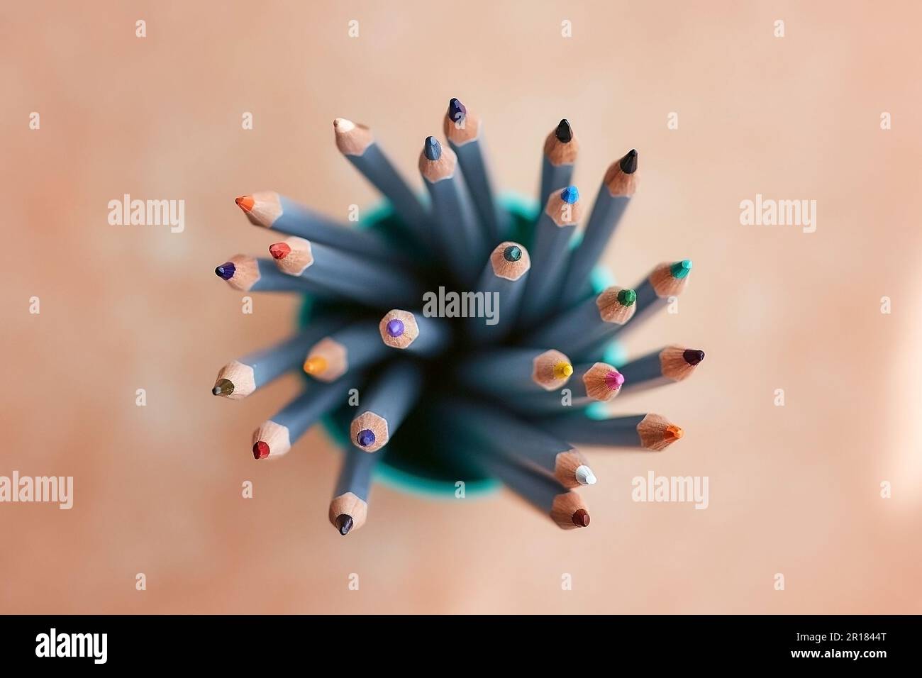 many sharpened colored pencils in a tube top view Stock Photo - Alamy