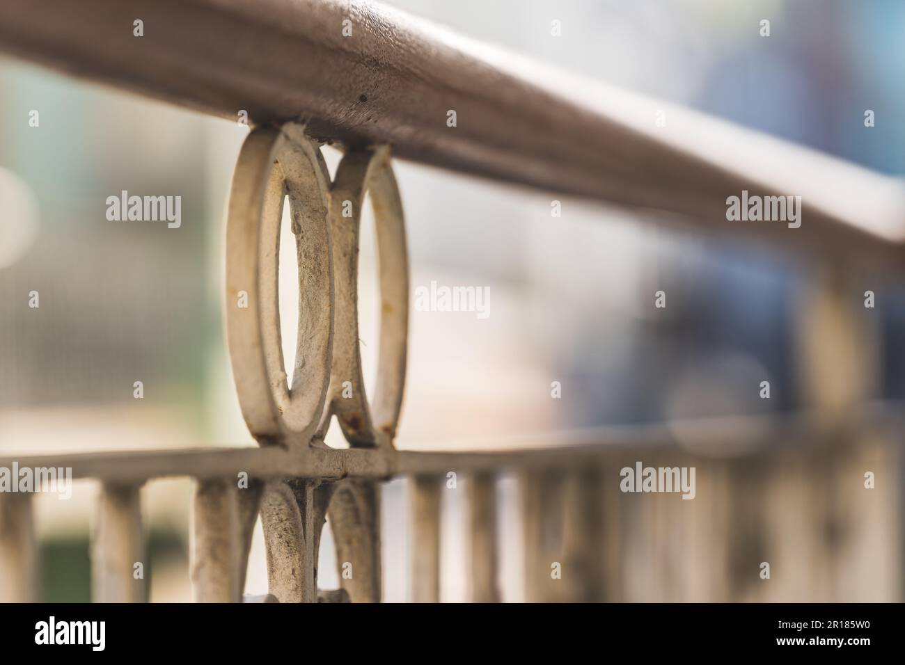white ornamental cast iron forged railing background focus Close up ...