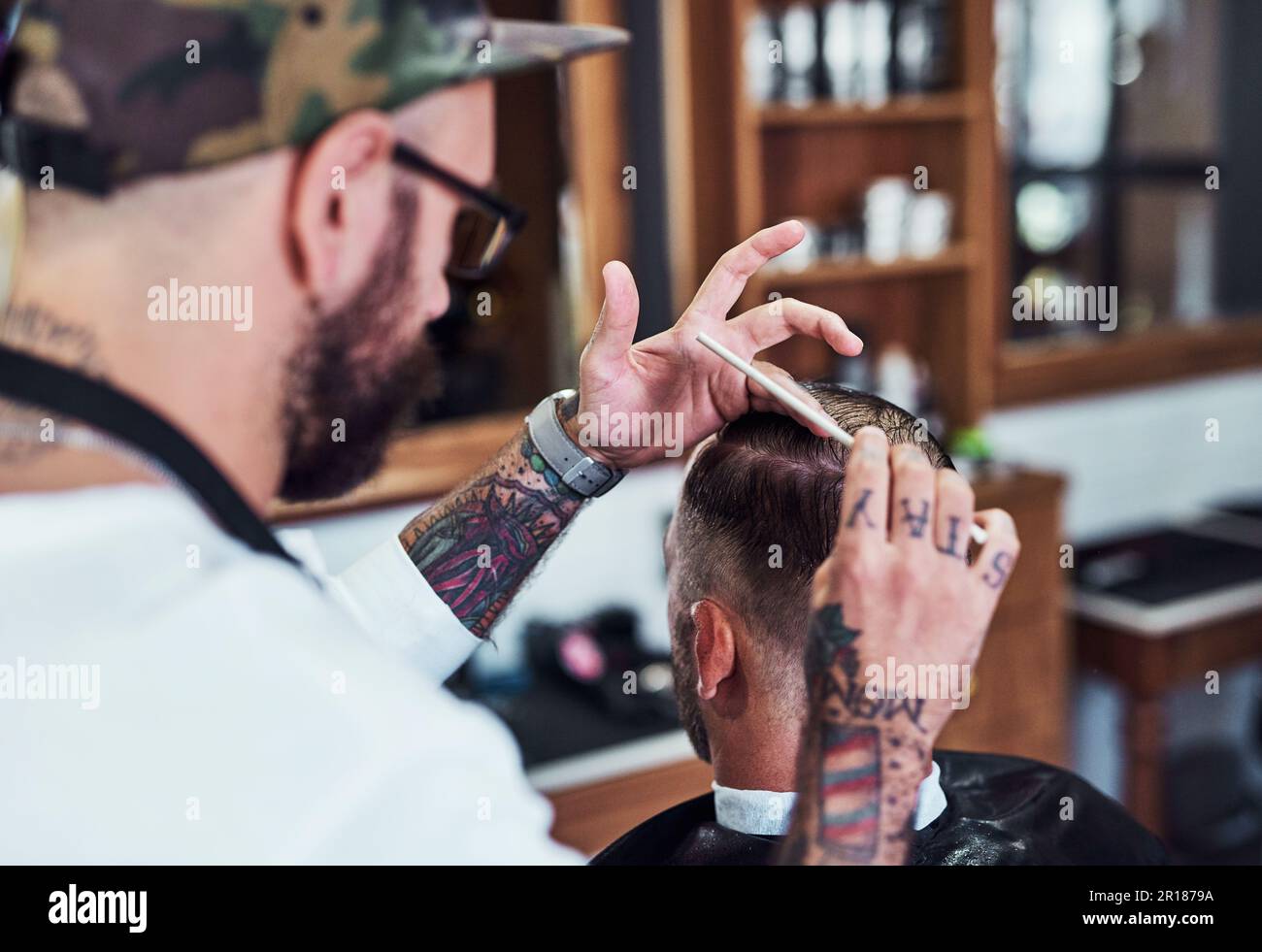 Detail makes all the difference. a handsome young barber giving a ...