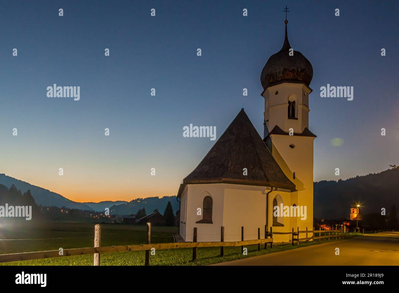 Typical small church in Austrian village Tannheim in Tyrol during dusk ...