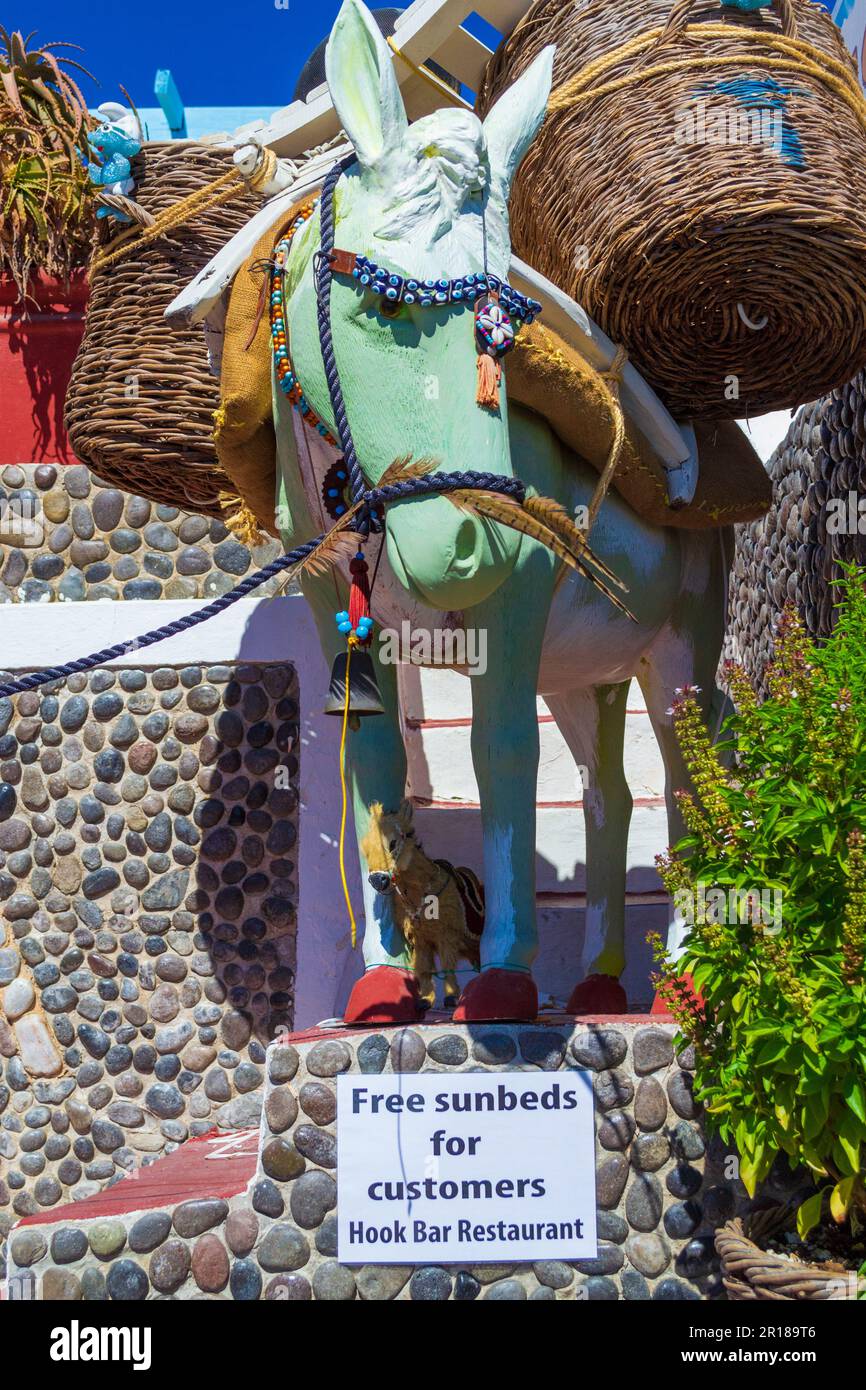 Donkey statue tourist attraction with rattan baskets at Kamari village ...