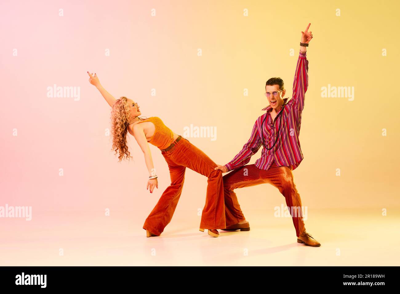 Artistic, expressive couple, man and woman emotionally dancing disco ...