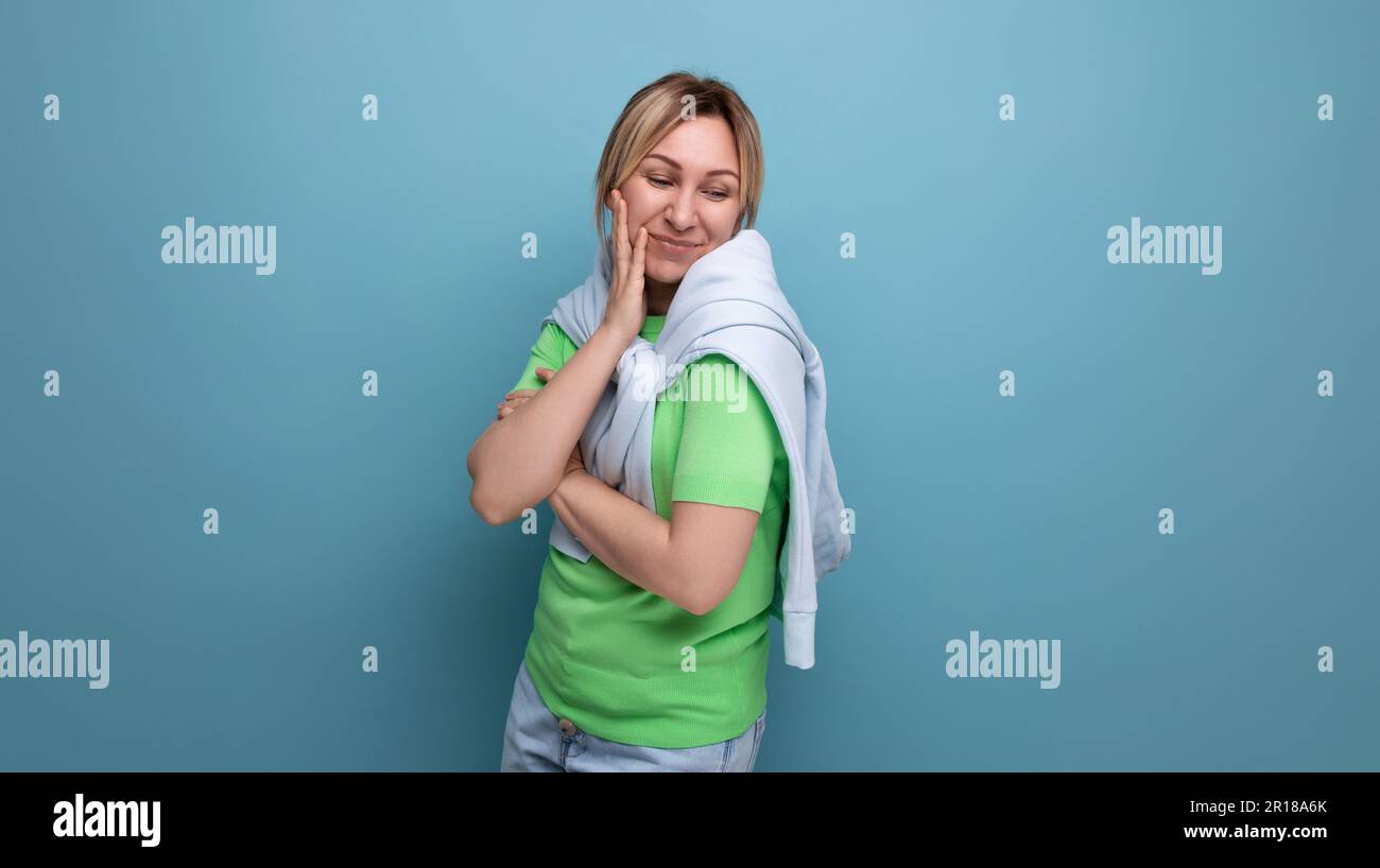 portrait of blonde positive modest young woman in casual outfit on ...