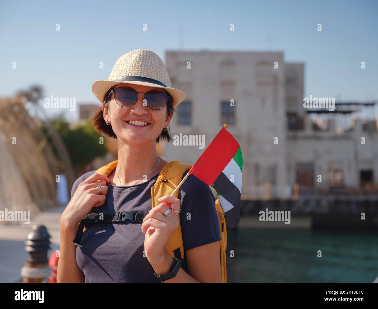 tourist trip to old Dubai, UAE. Asian Woman tourist holding UAE flag in ...