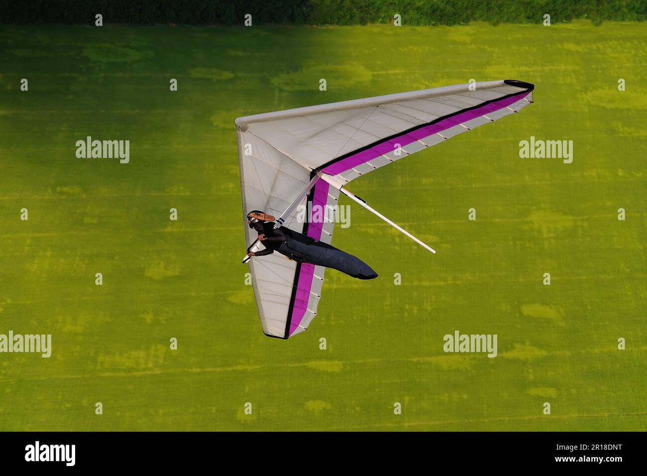 Hang glider pilot playing with his wing in the air. Aerial photo of ...