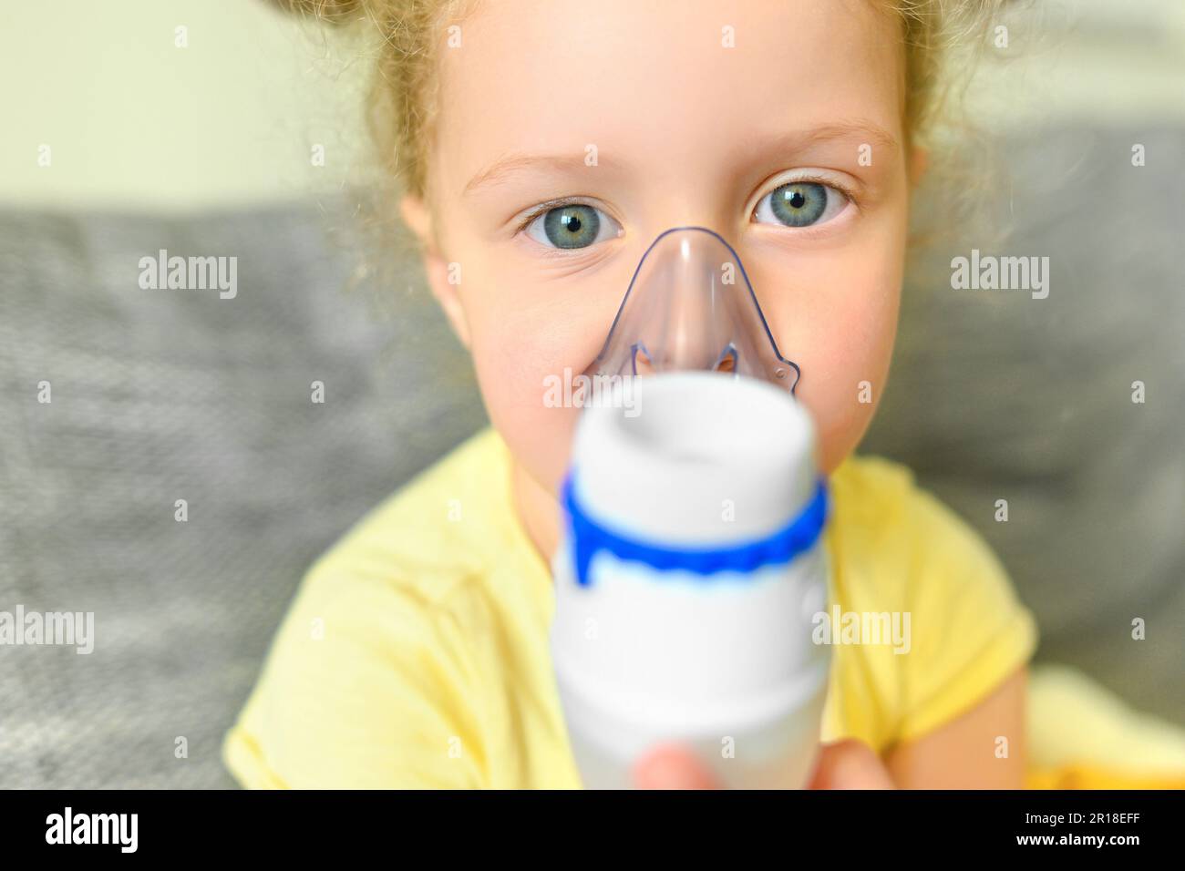 The child shows the OK sign when breathing through the inhaler Stock ...