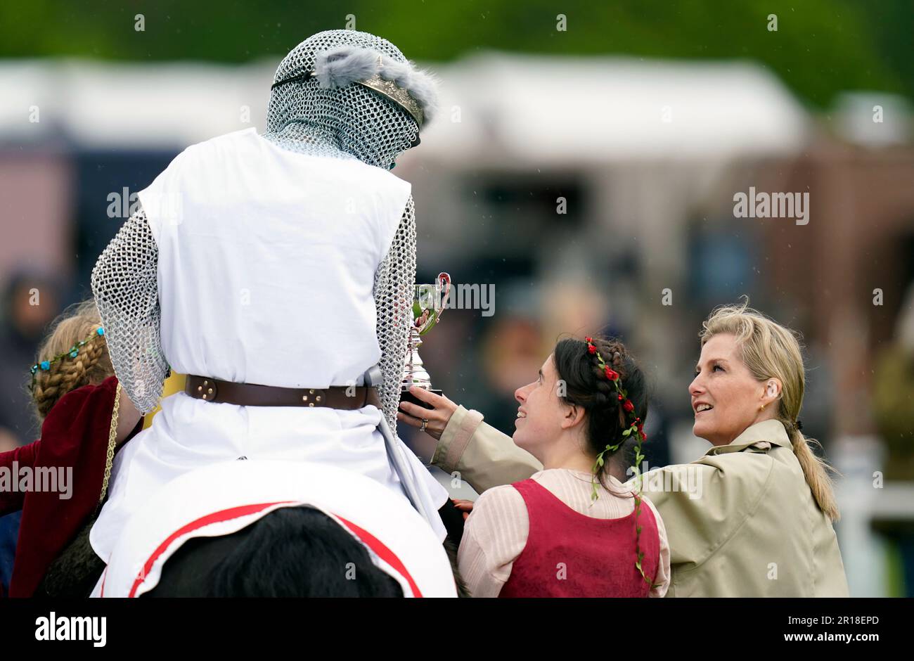 The Duchess of Edinburgh (right) presents a trophy to the winning group ...