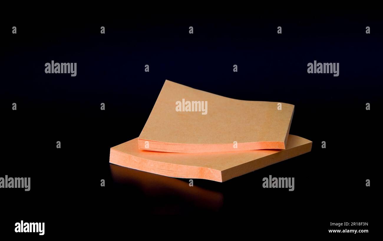 Sticky orange paper notes on black background Stock Photo - Alamy