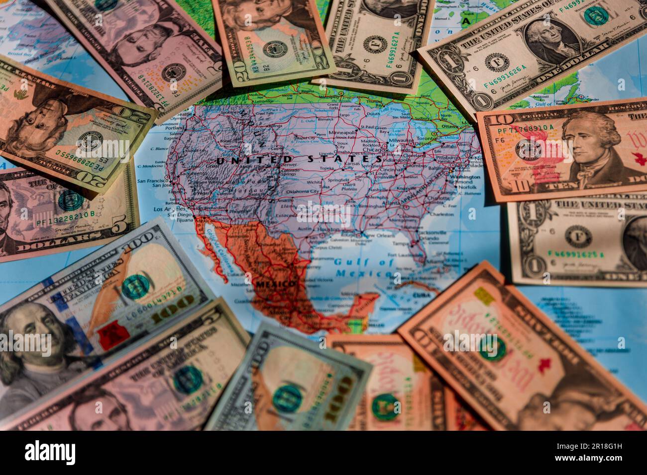 a map of the USA with one dollar notes arranged in an arrow pointing in ...