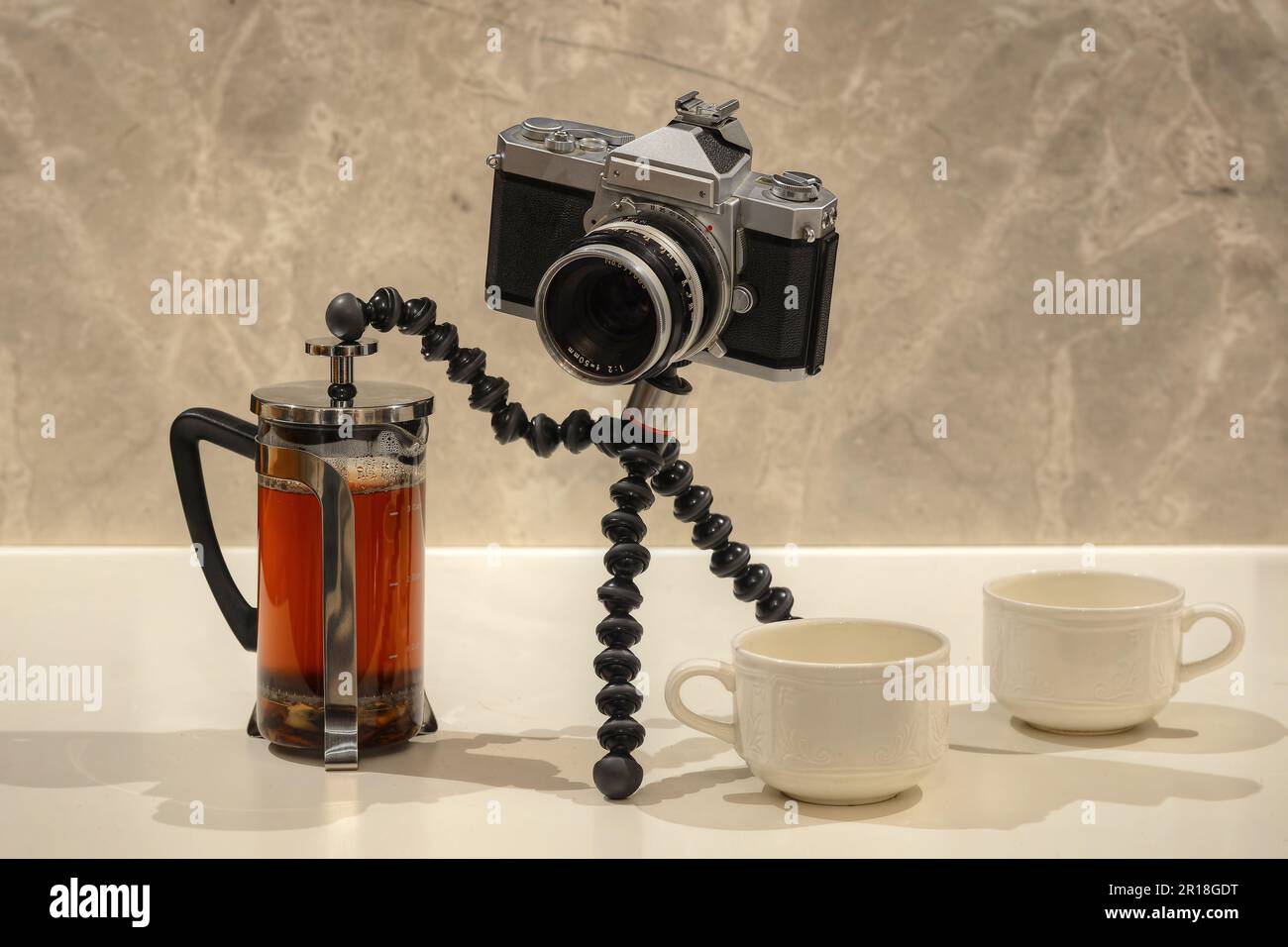 A photo of an old SLR camera making tea with a french press Stock Photo ...
