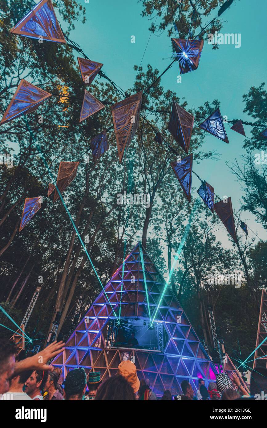 A group of people enjoying the Noisily Festival under a canopy of lights in vibrant colors Stock Photo Alamy
