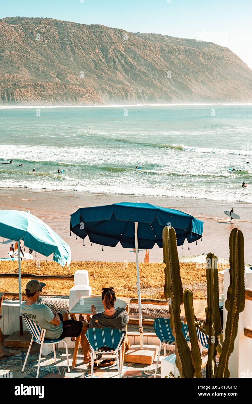 A group of people are enjoying a sunny day at the beach in Morocco ...