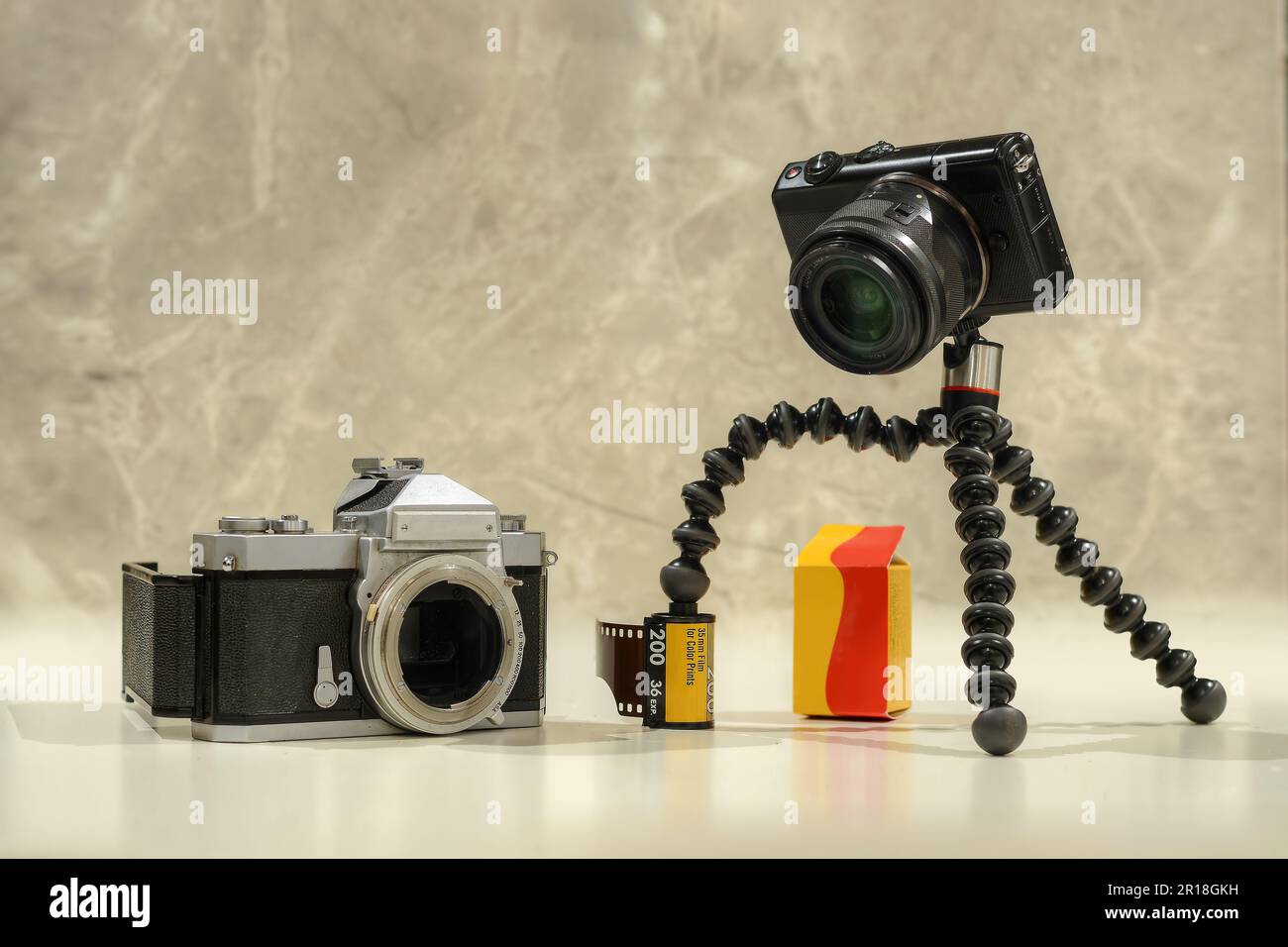 A new camera replacing film cartridge to an old reflex camera Stock ...