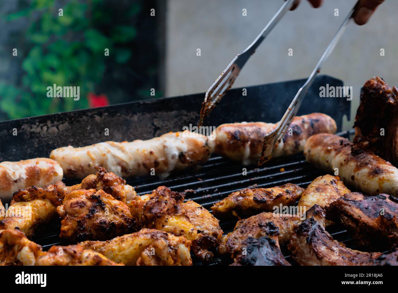 Marinated meat, chicken, ribs and sausages put on the barbecue Stock ...