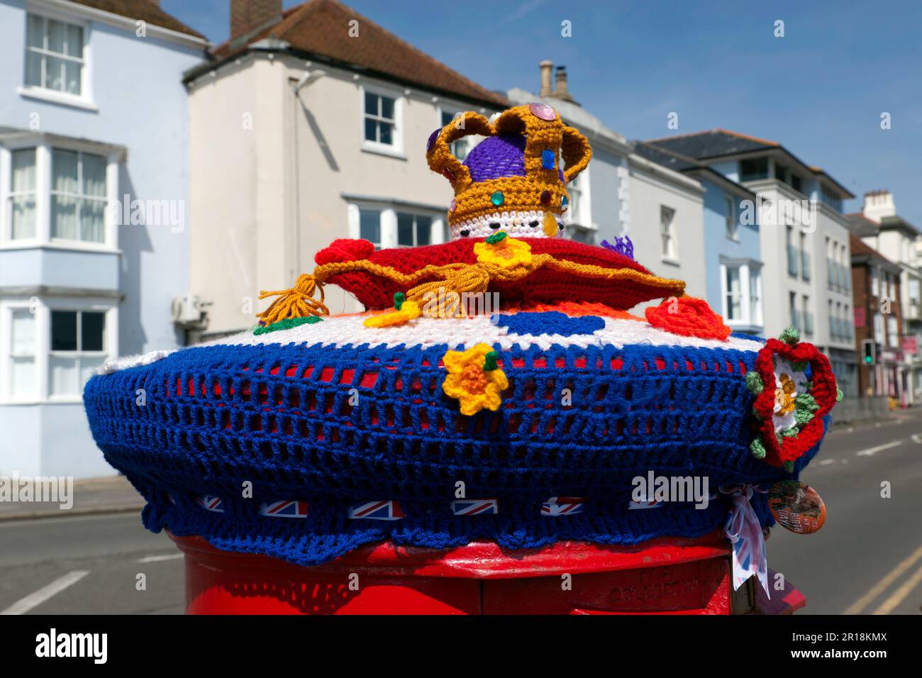 Close-up of a Red Post Box is fitted with a fitted with a knitted Royal ...