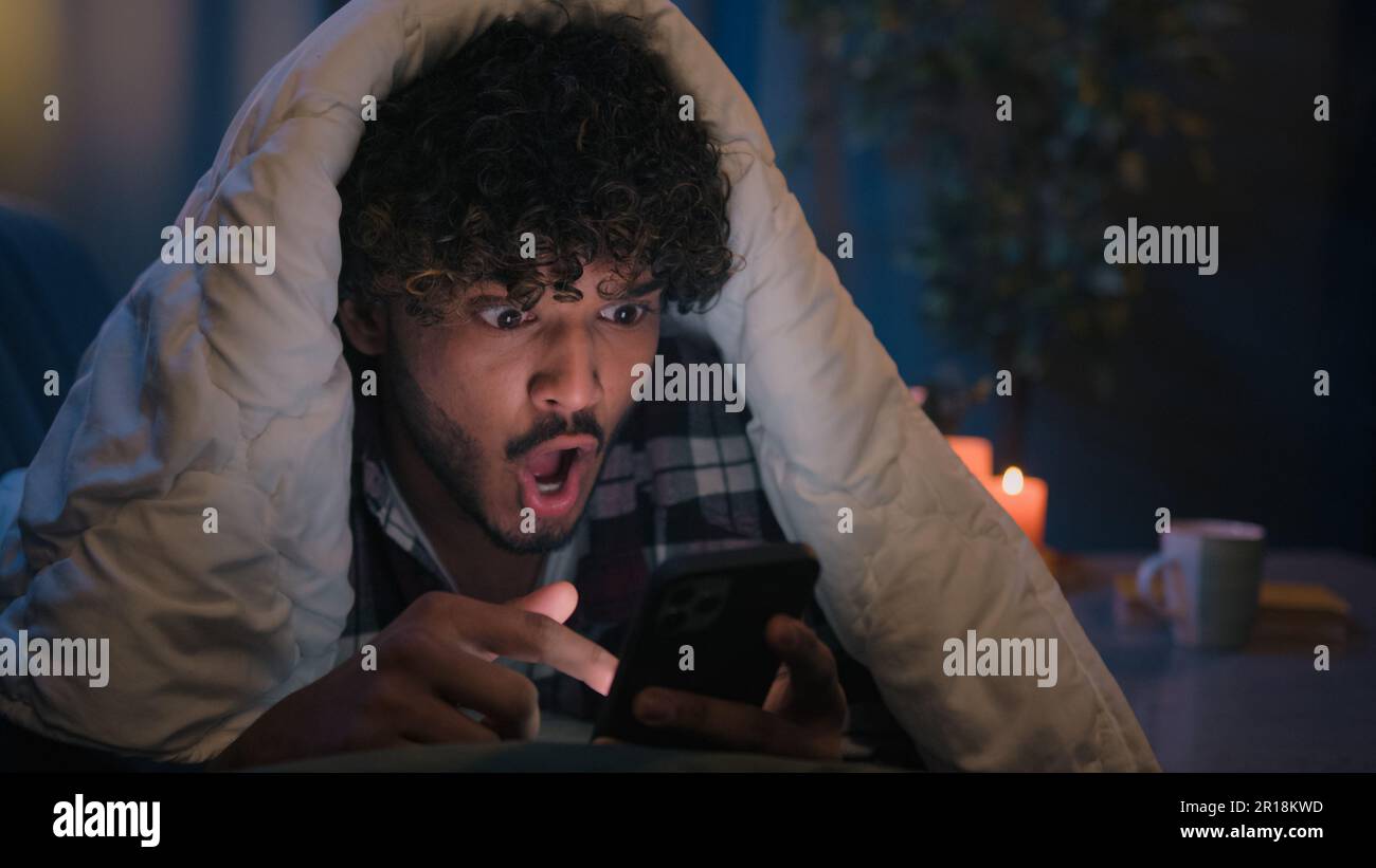 Shocked guy Indian man Arabian male shock wonder reading news in phone ...