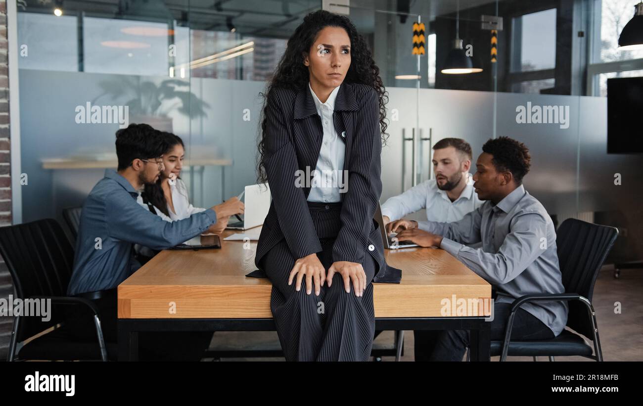 Worried sad upset leader woman worker businesswoman sitting on table in ...