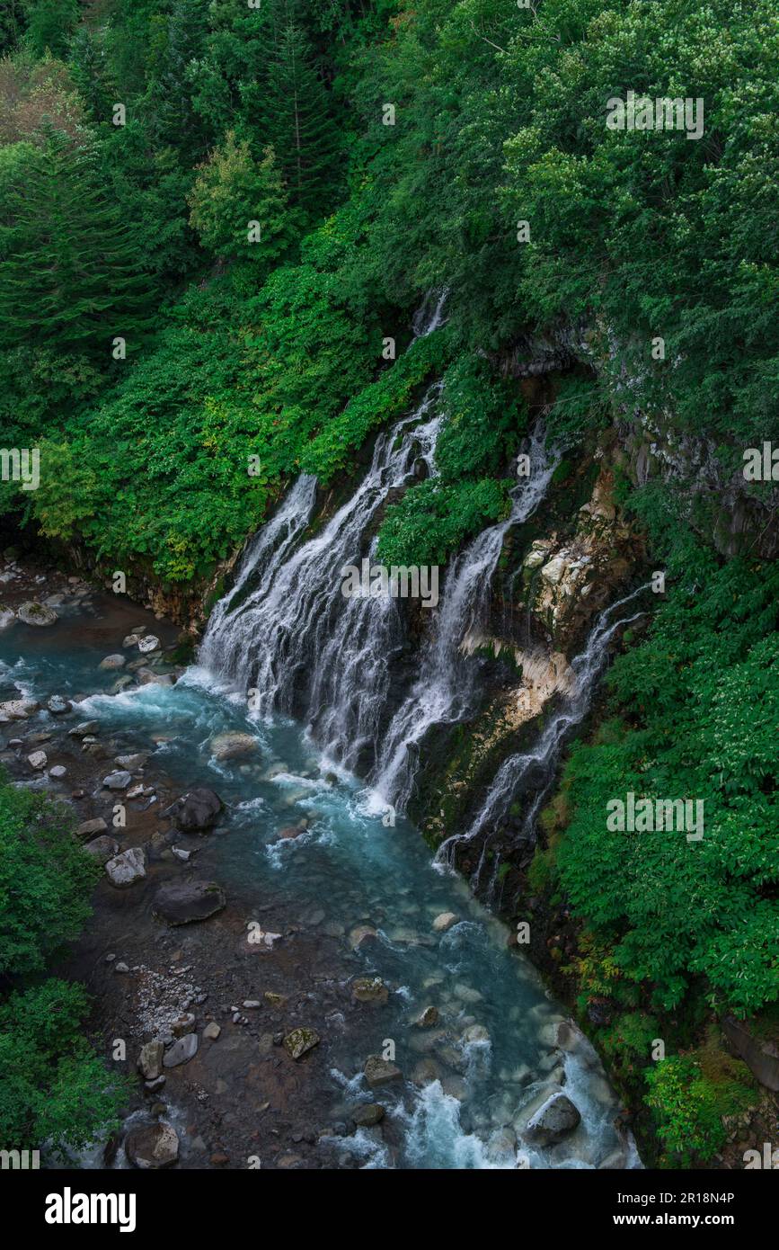 Shirahige waterfall flowing into Emerald Green River Stock Photo - Alamy